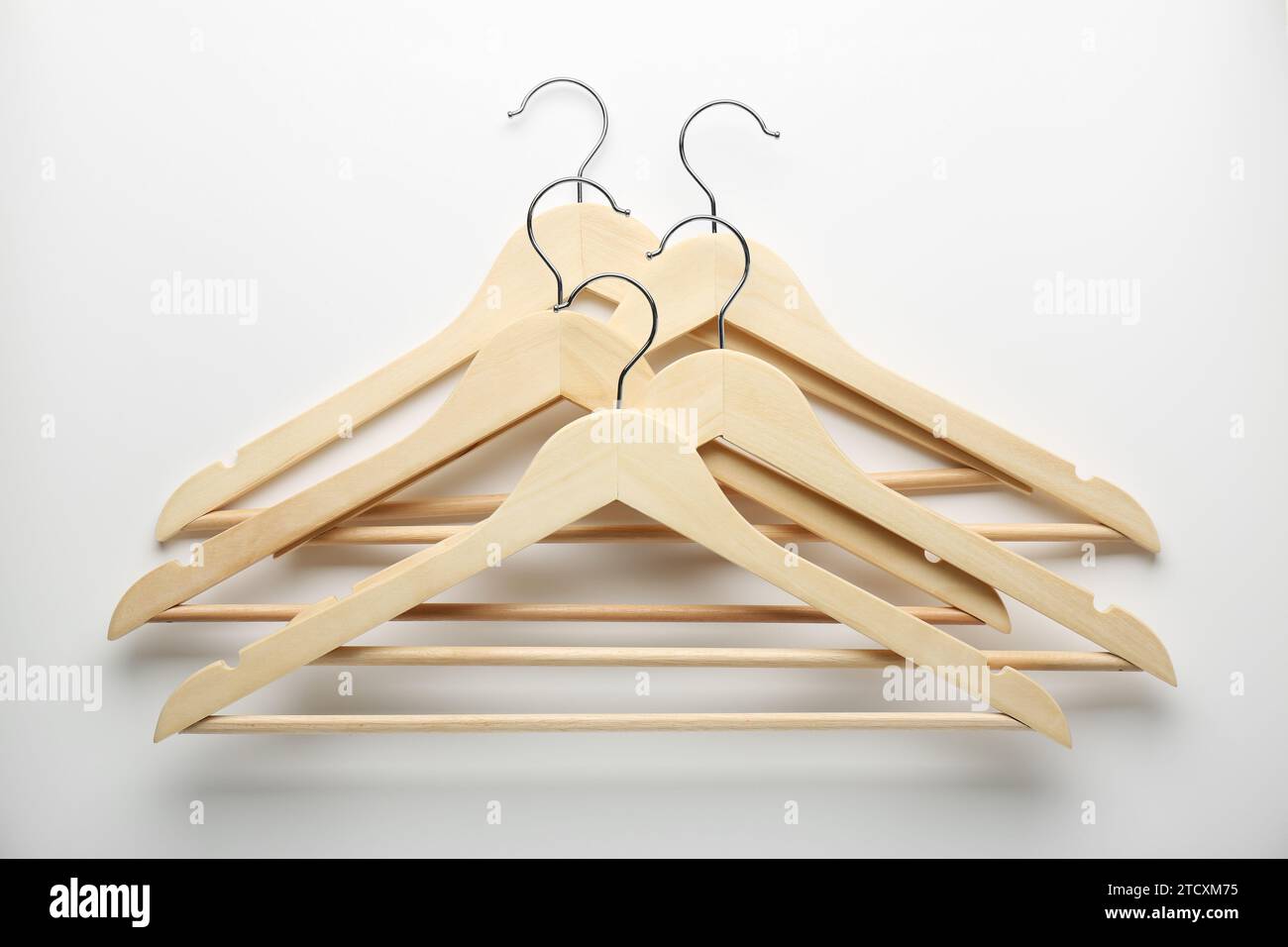 Wooden hangers on white background, top view Stock Photo - Alamy