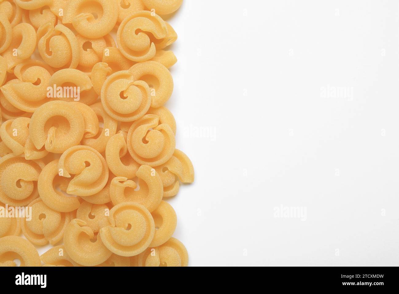 Raw dischi volanti pasta on white background, top view. Space for text ...