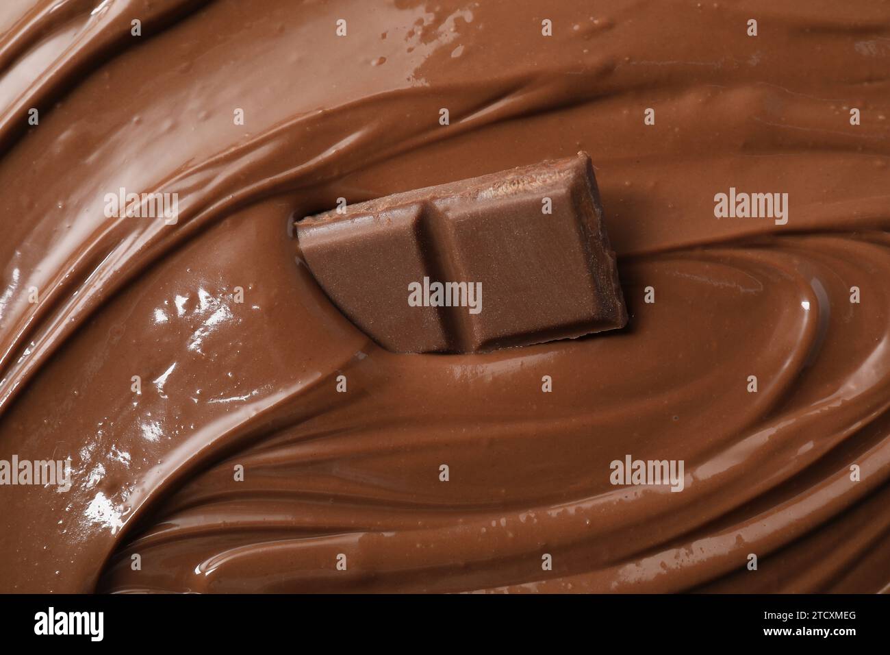 Tasty milk chocolate paste and pieces as background, closeup Stock ...