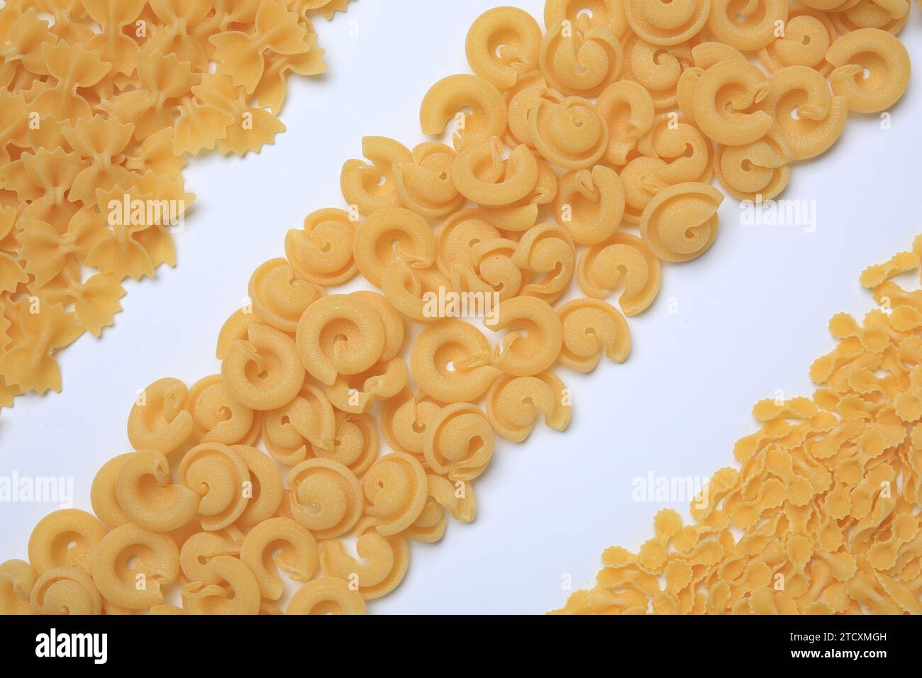 Different types of raw pasta on white background, flat lay Stock Photo ...