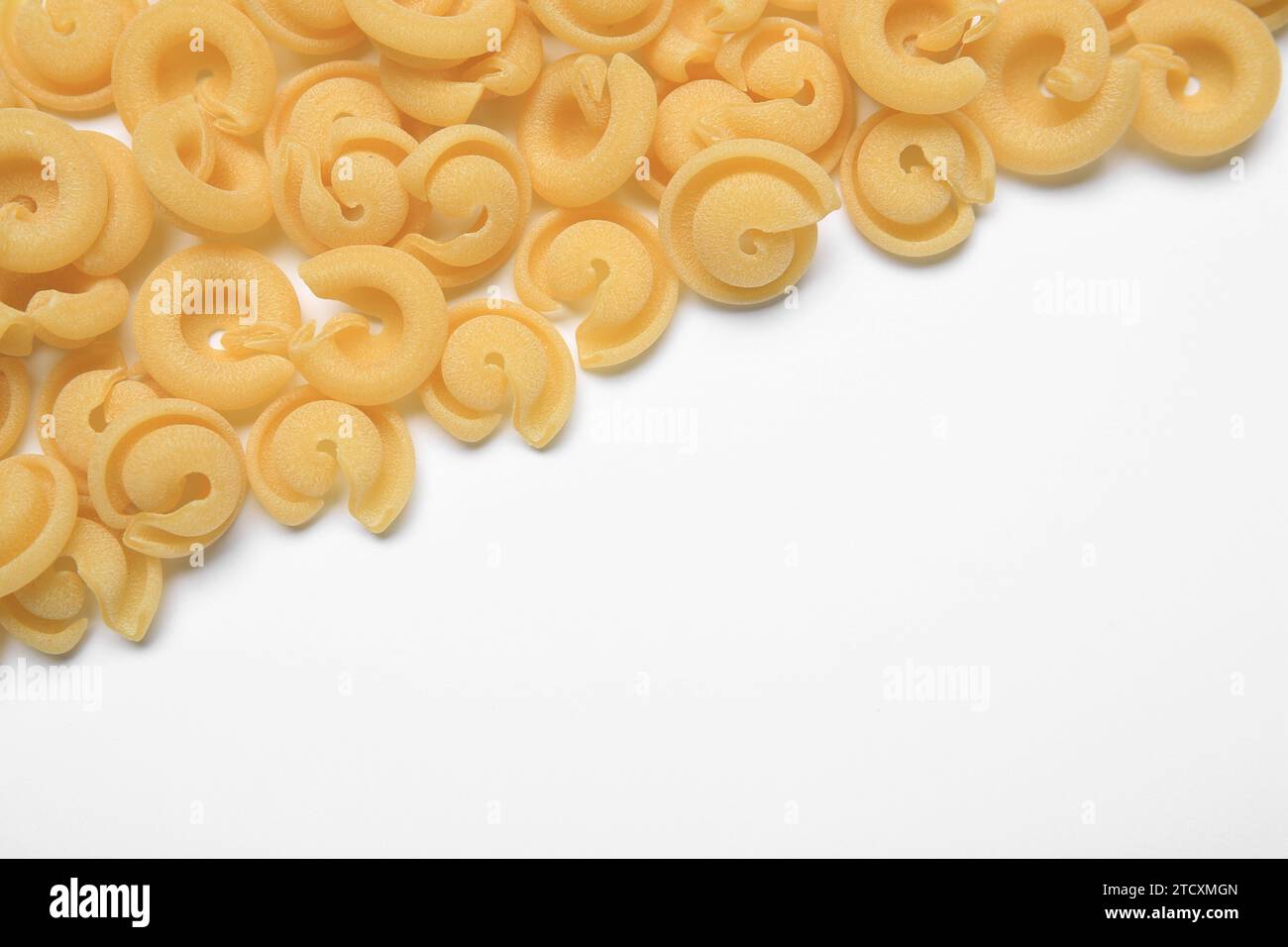 Raw dischi volanti pasta on white background, top view. Space for text ...