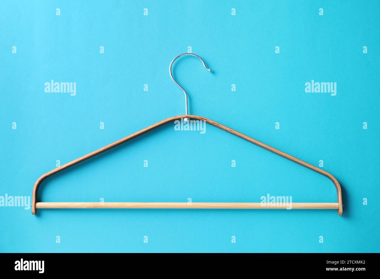 One wooden hanger on light blue background, top view Stock Photo - Alamy