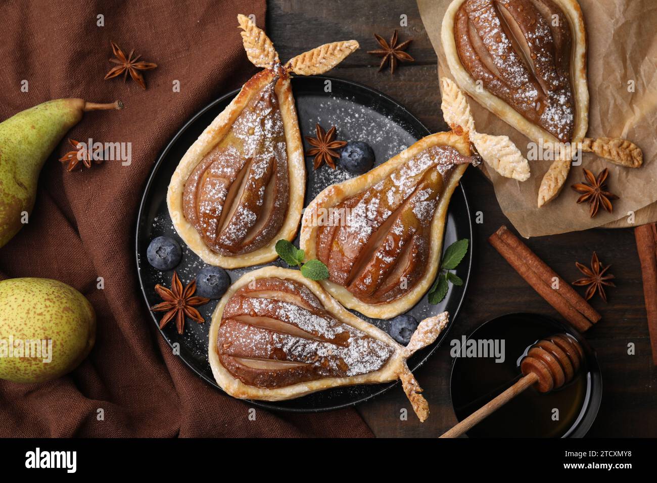 Delicious pears baked in puff pastry with powdered sugar served on ...
