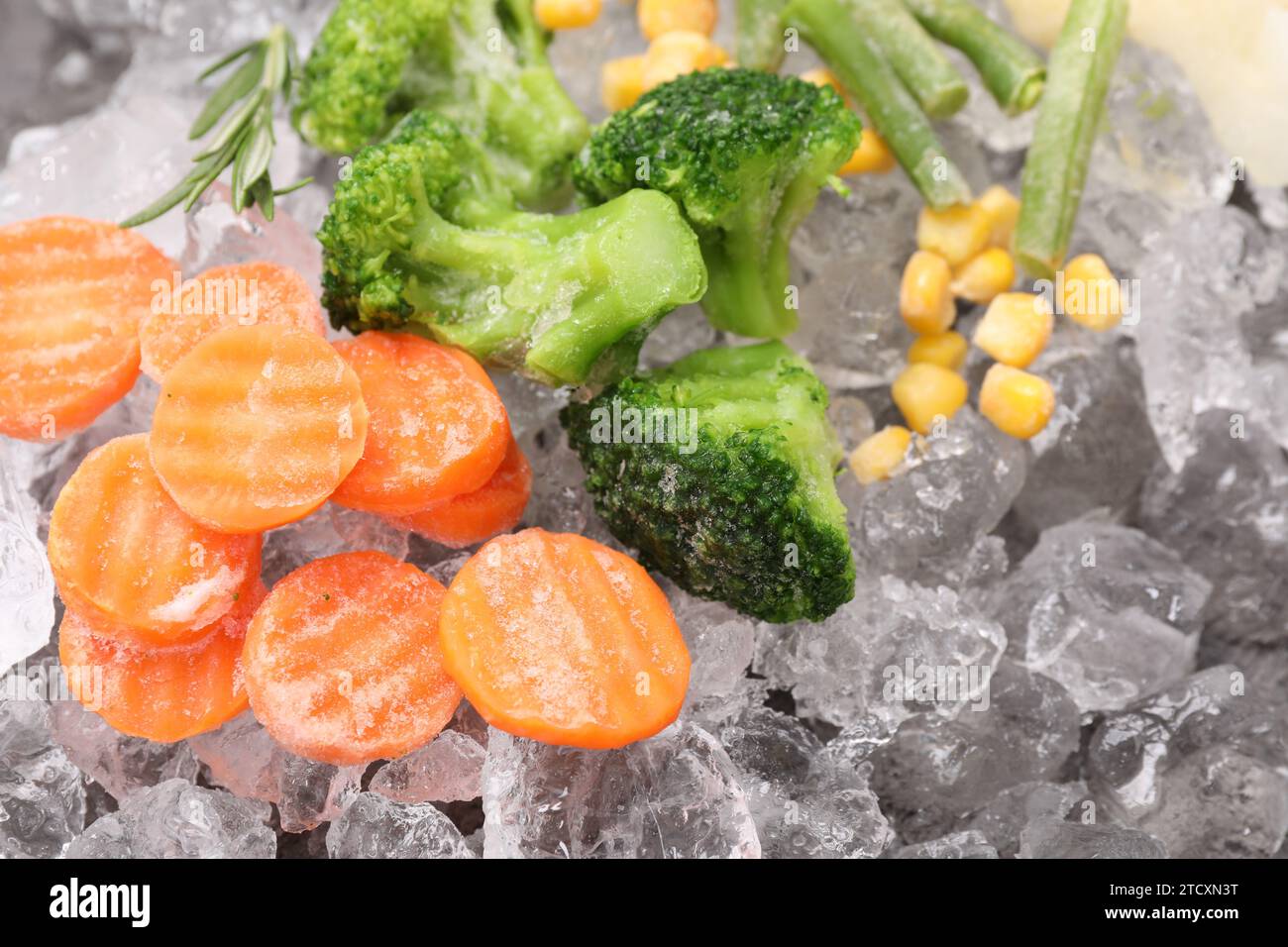 Different frozen vegetables on ice, flat lay Stock Photo - Alamy