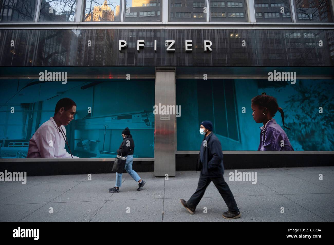 New York, USA. 14th Dec, 2023. People walk past Pfizer World ...