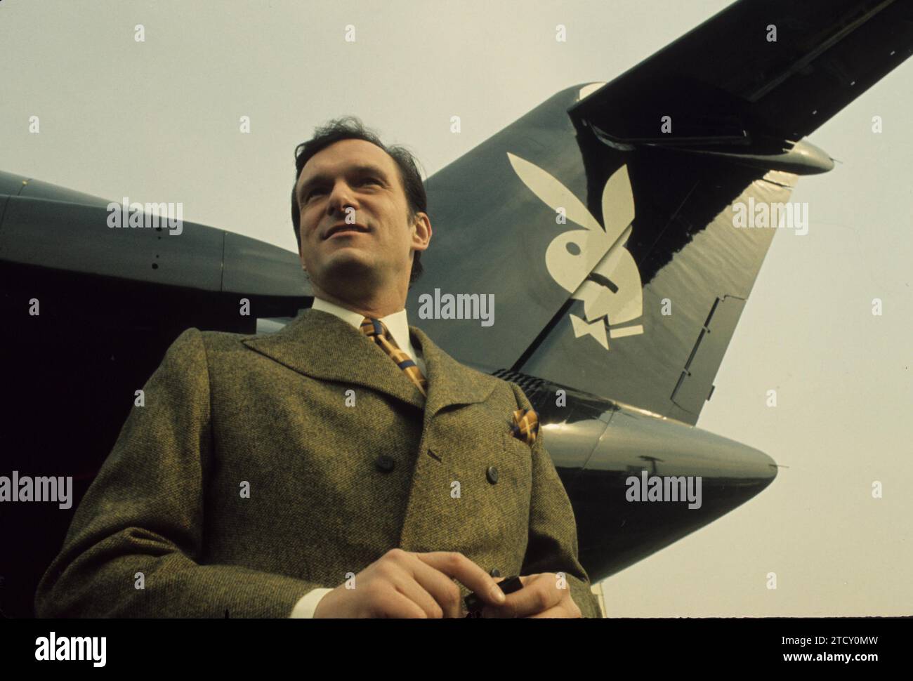 A young HUGH HEFNER by a jet with his Playboy Bunny logo on tail ...