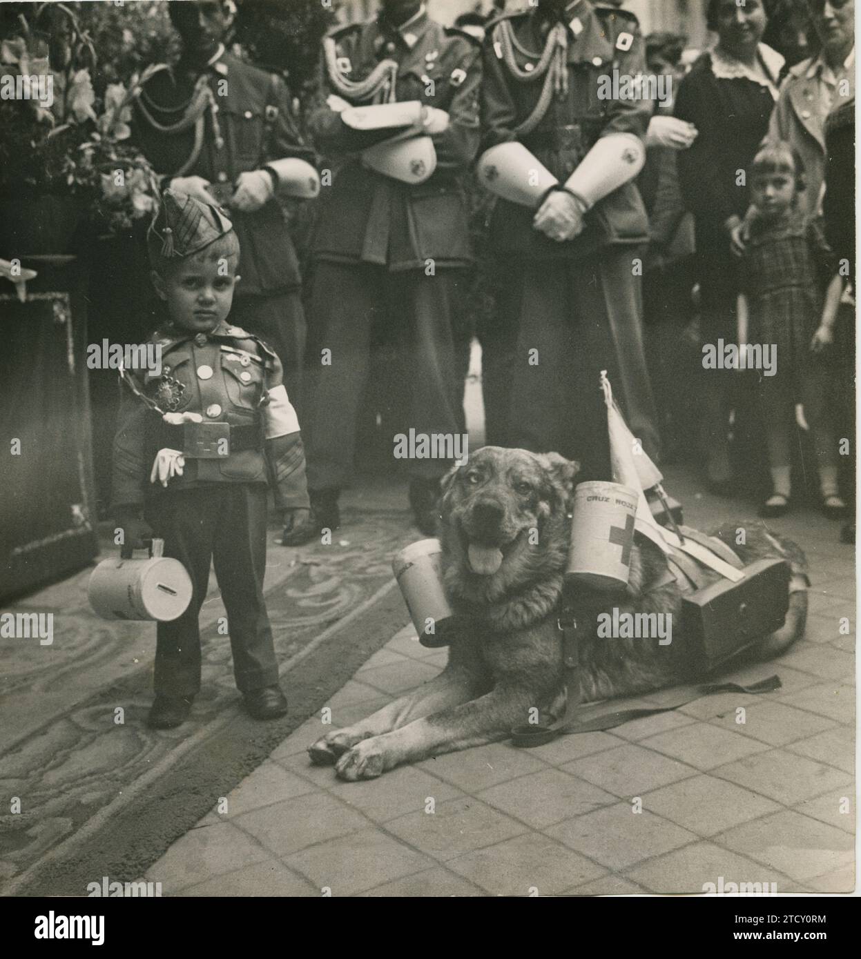 Madrid, 06/14/1957. A boy dressed as a Red Cross corporal, accompanied ...