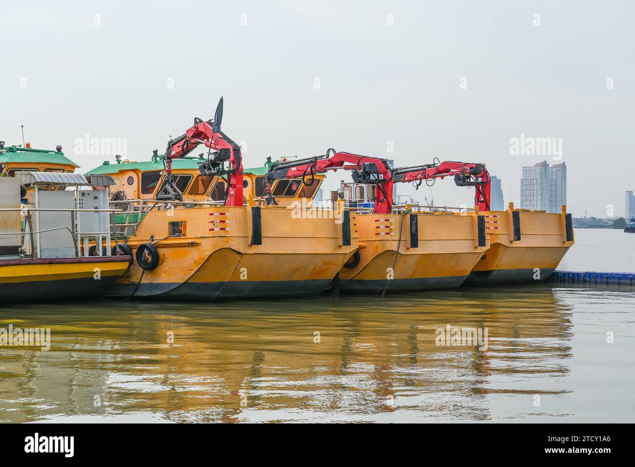 Small several row of ships with a claw manipulator hand parked at the ...