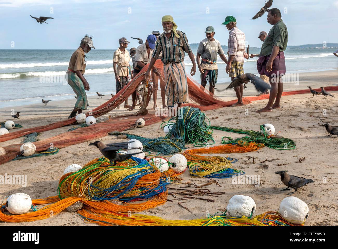 Seine fishermen pull their fishing nets from the Indian Ocean onto ...