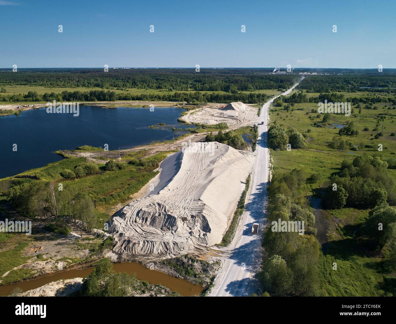 Huge mound of extracted river sand near pond in open quarry Stock Photo ...