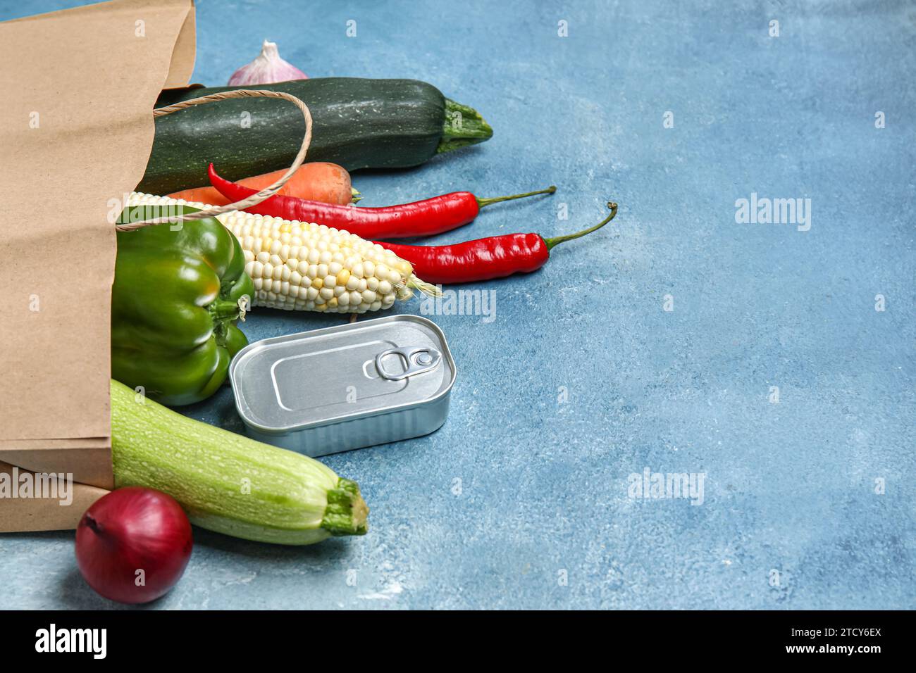 Paper bag full of fresh vegetables on grunge blue background Stock ...