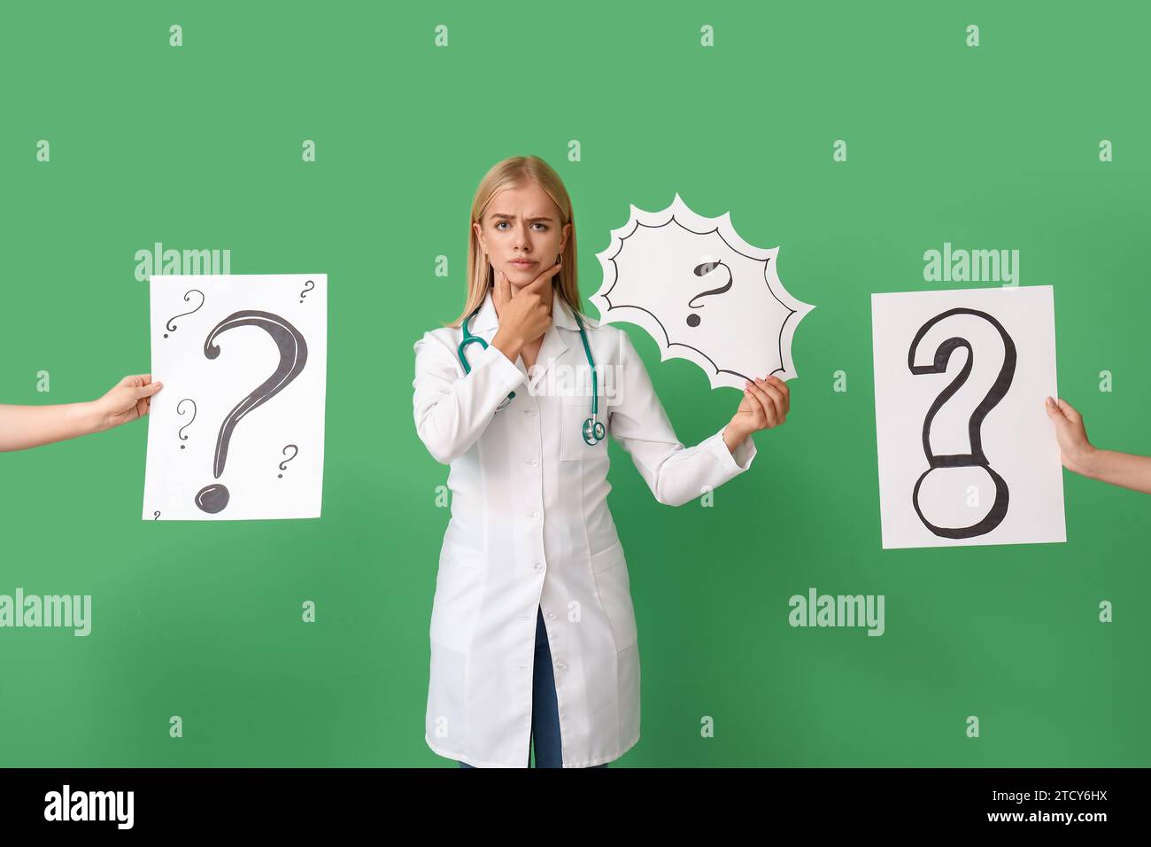 Female doctor and hands holding papers with question marks on green ...