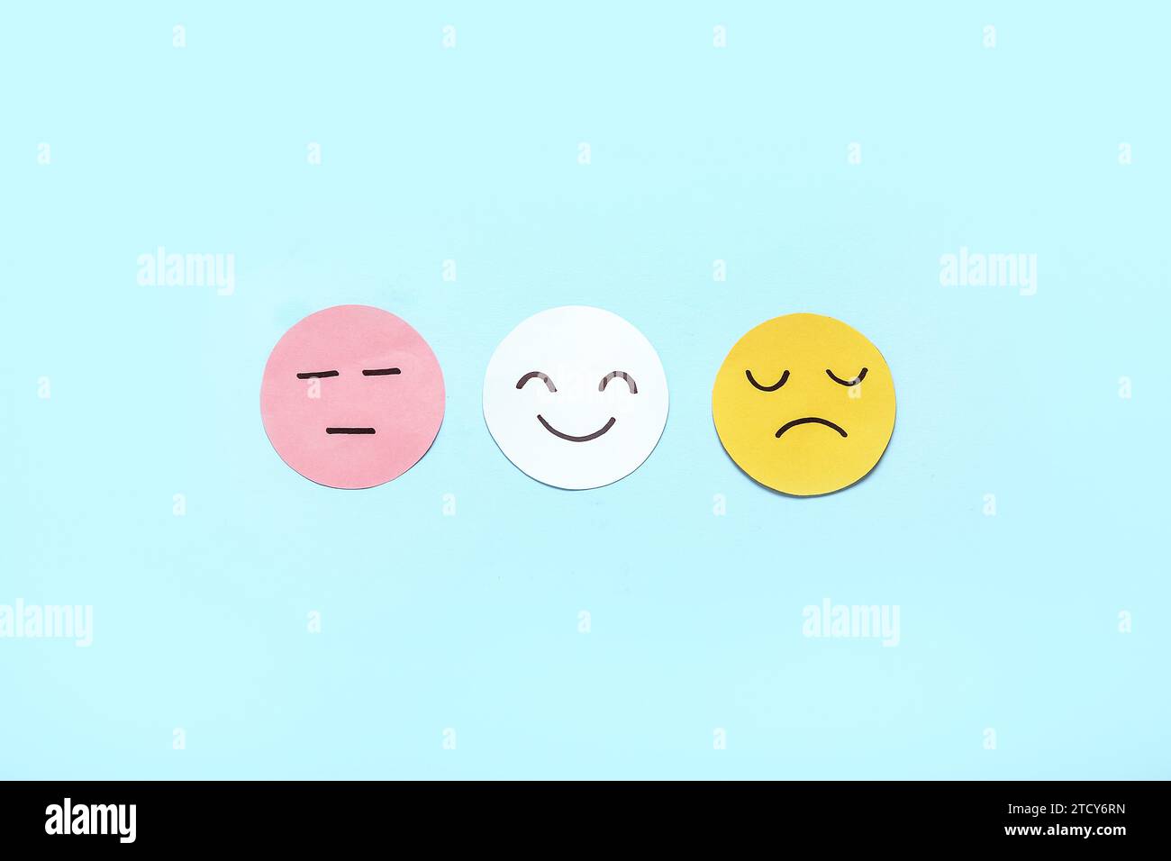 Paper faces with different emotions on blue background. Mental Health ...