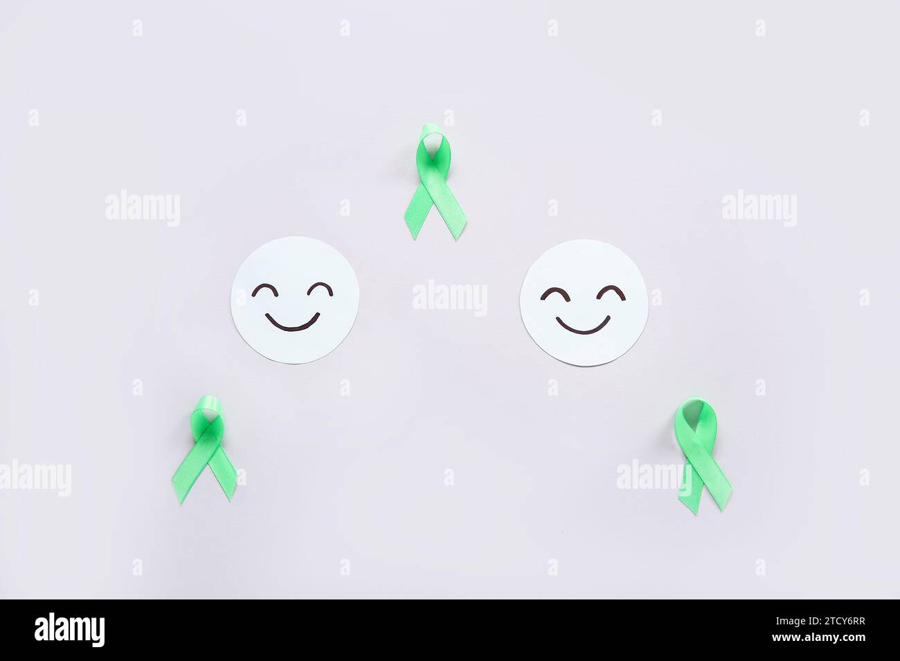 Happy smile faces with green awareness ribbons on grey background ...