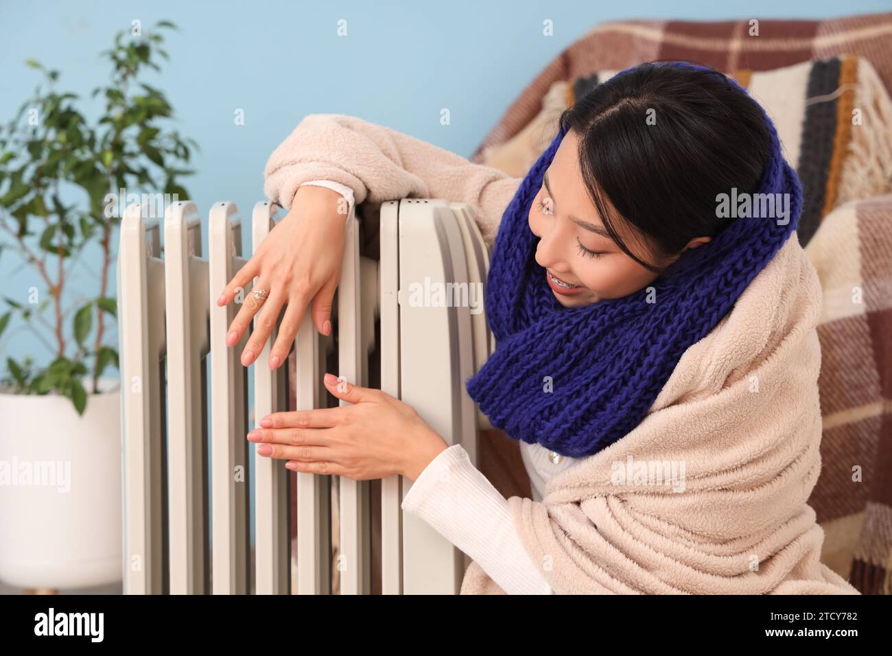 Young Asian woman with radiator at home Stock Photo - Alamy