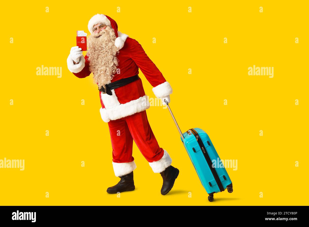 Santa Claus with suitcase, tickets and passport on yellow background ...