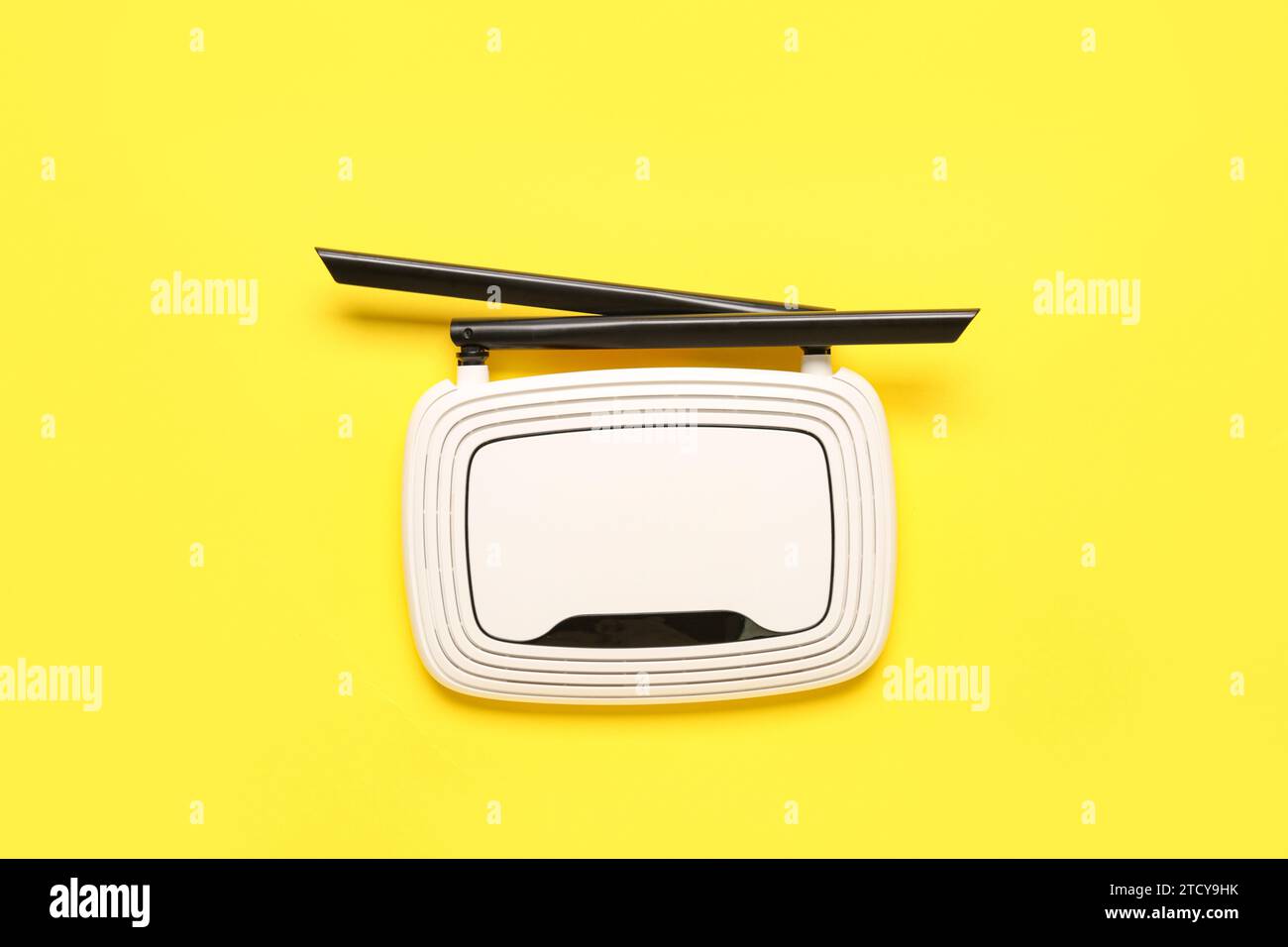 Modern wi-fi router on yellow background Stock Photo - Alamy