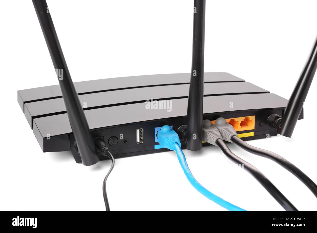 Modern wi-fi router with cables on white background Stock Photo - Alamy