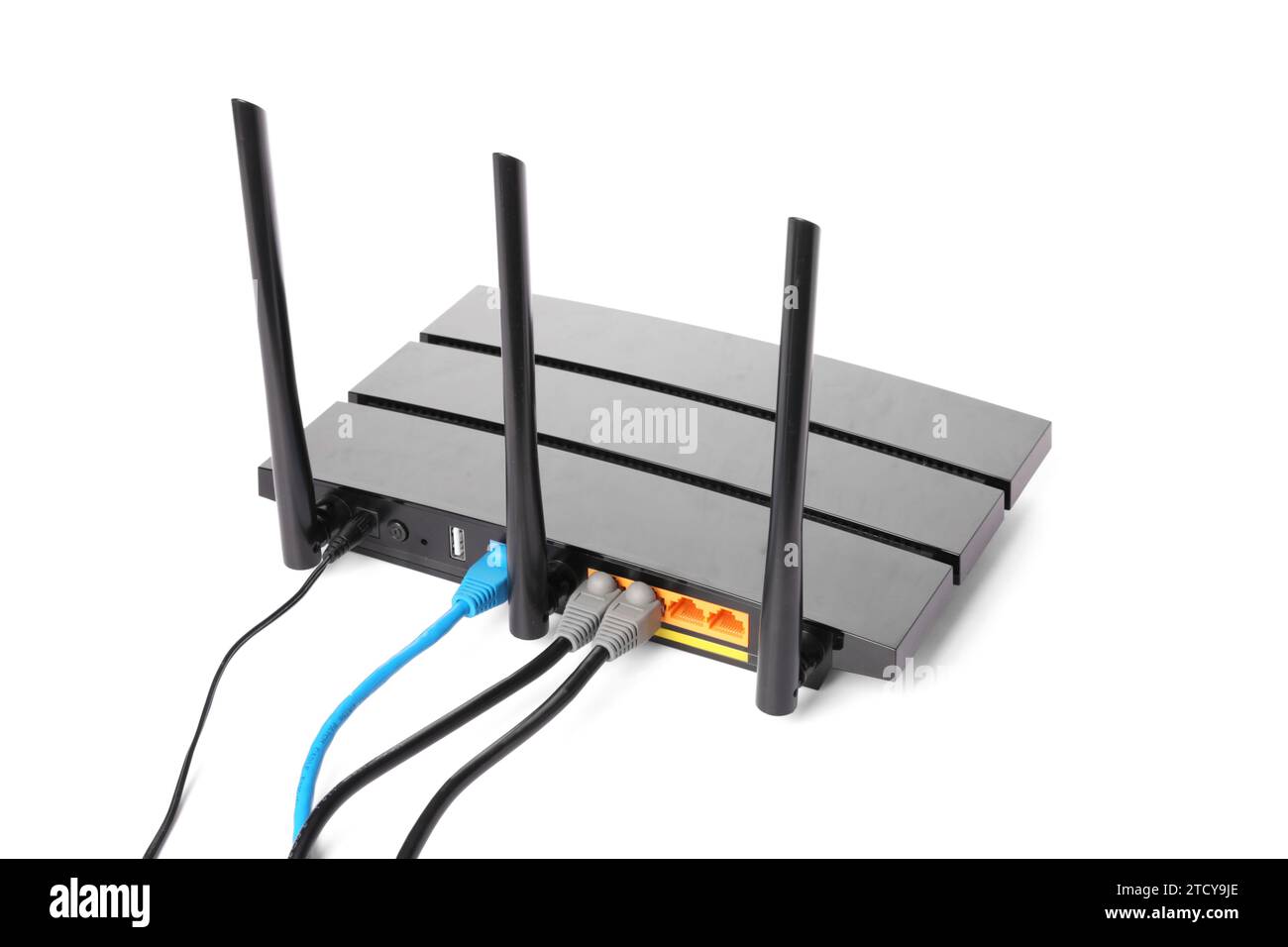 Modern wi-fi router with cables on white background Stock Photo - Alamy
