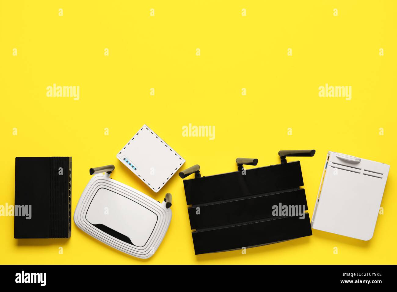 Modern wi-fi routers on yellow background Stock Photo - Alamy