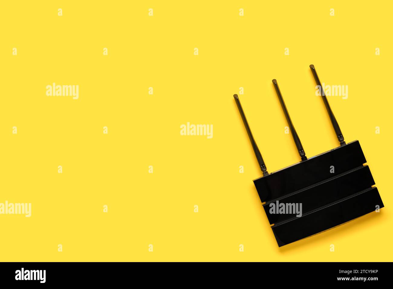 Modern wi-fi router on yellow background Stock Photo - Alamy