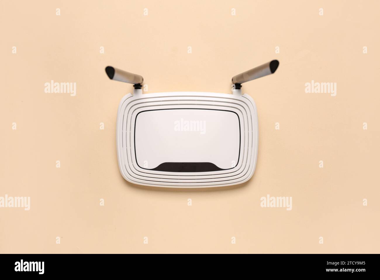 Modern wi-fi router on beige background Stock Photo - Alamy