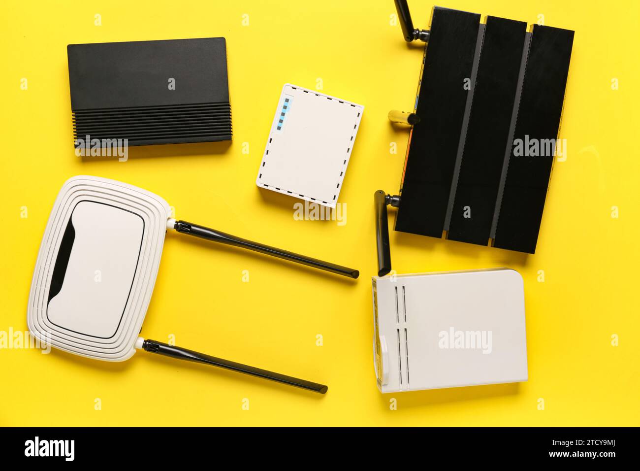 Modern wi-fi routers on yellow background Stock Photo - Alamy