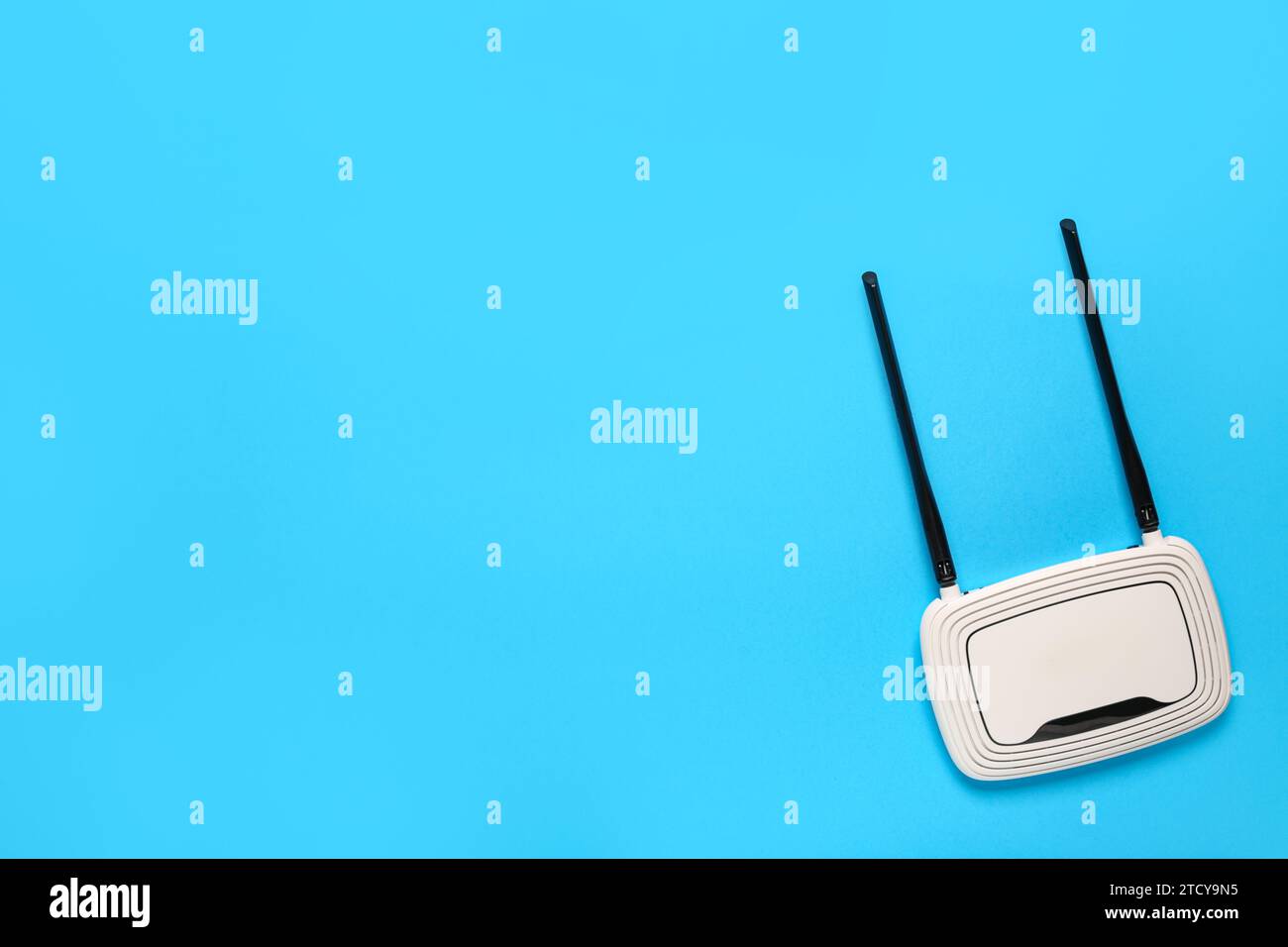 Modern wi-fi router on blue background Stock Photo - Alamy