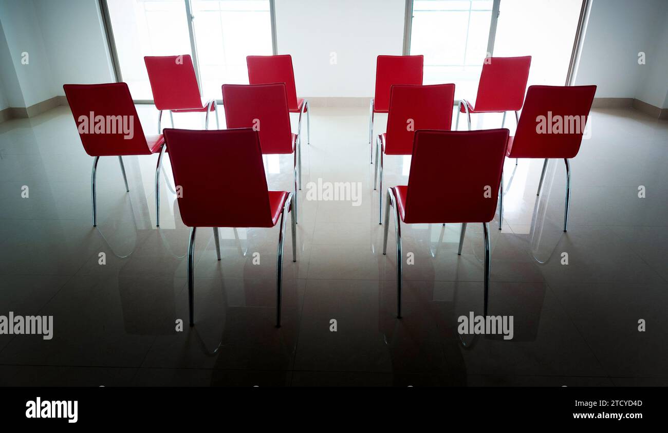 Group of red chairs in ordinary empty waiting room Stock Photo - Alamy