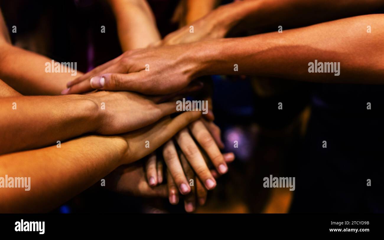 Sports team showing unity with their hands together Stock Photo - Alamy