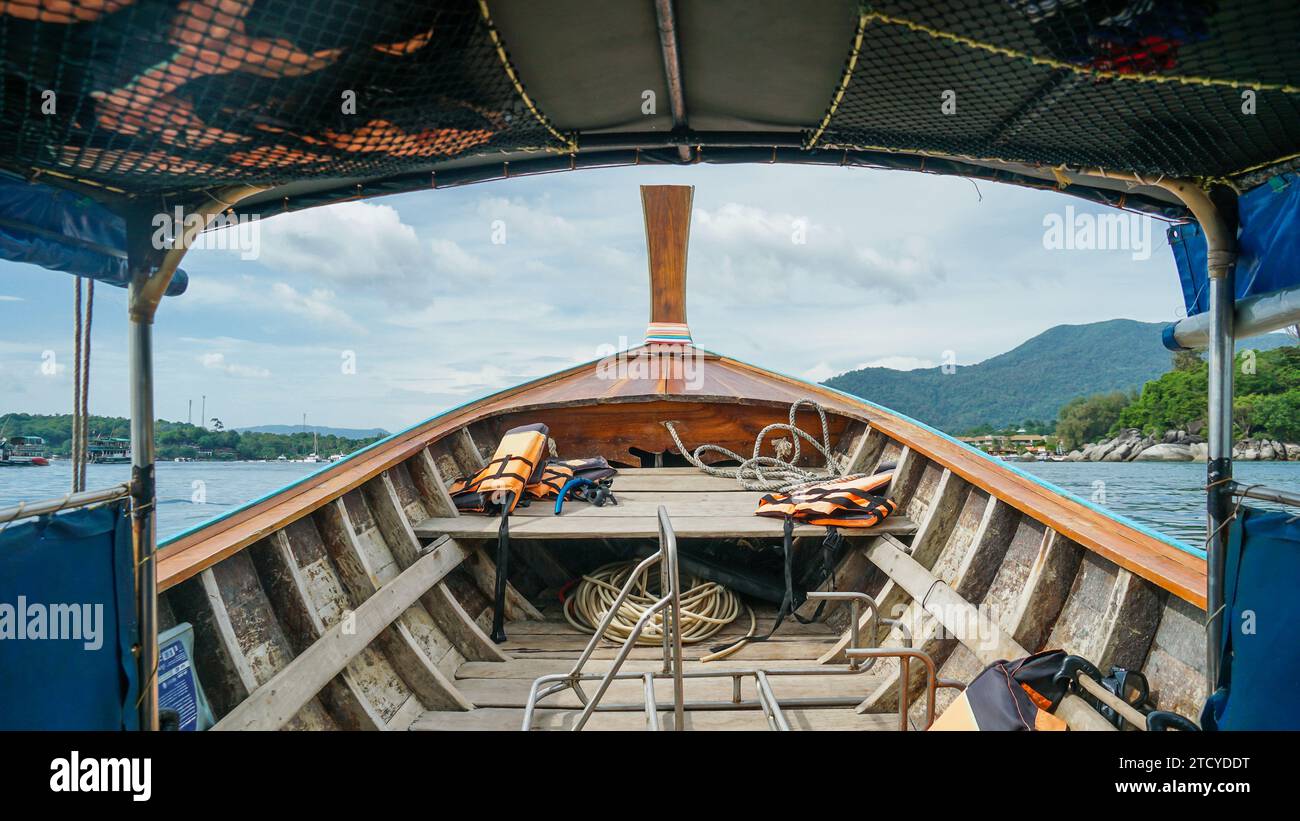Traditional wooden longtail taxi boat nose with decoration ribbons at ...
