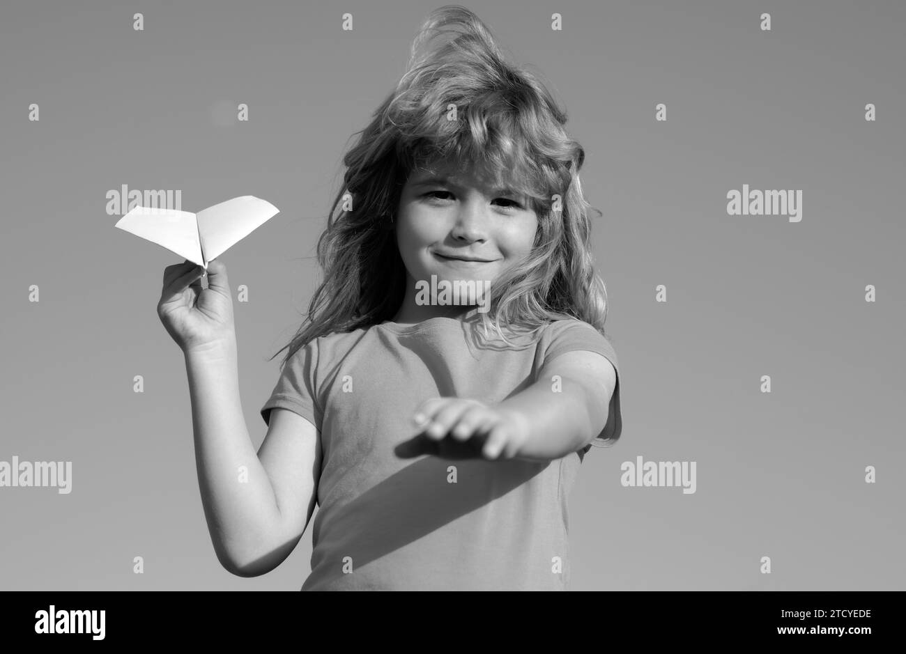Origami paper airplane. Kid boy throwing a paper plane with blue sky ...