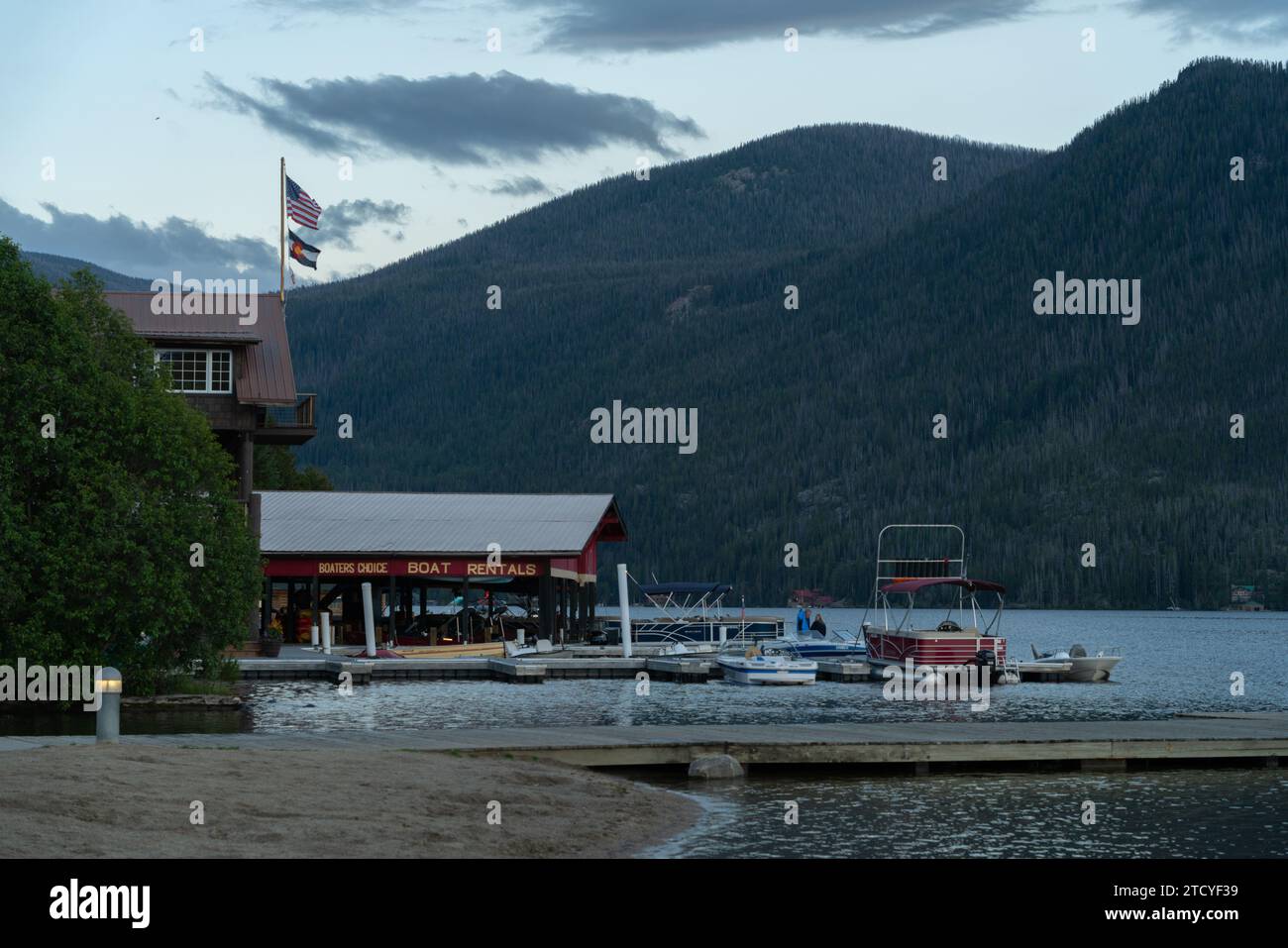 Twilight at Grand Lake marina with mountains and pine trees in Colorado ...