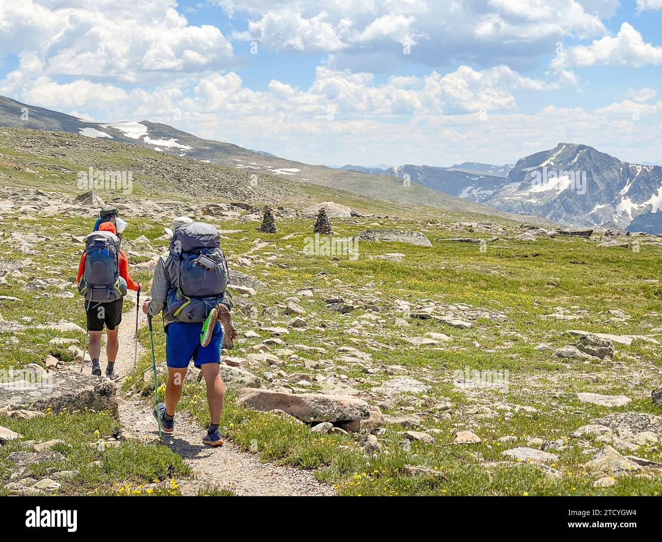 Hikers with backpacks traverse the rugged expanse of the North Inlet ...
