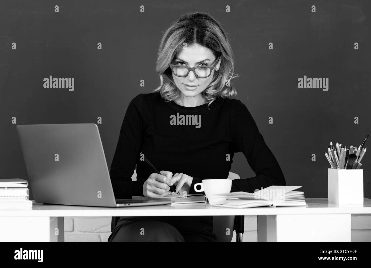 Serious concentrated teacher. Portrait of smart young woman in glasses ...