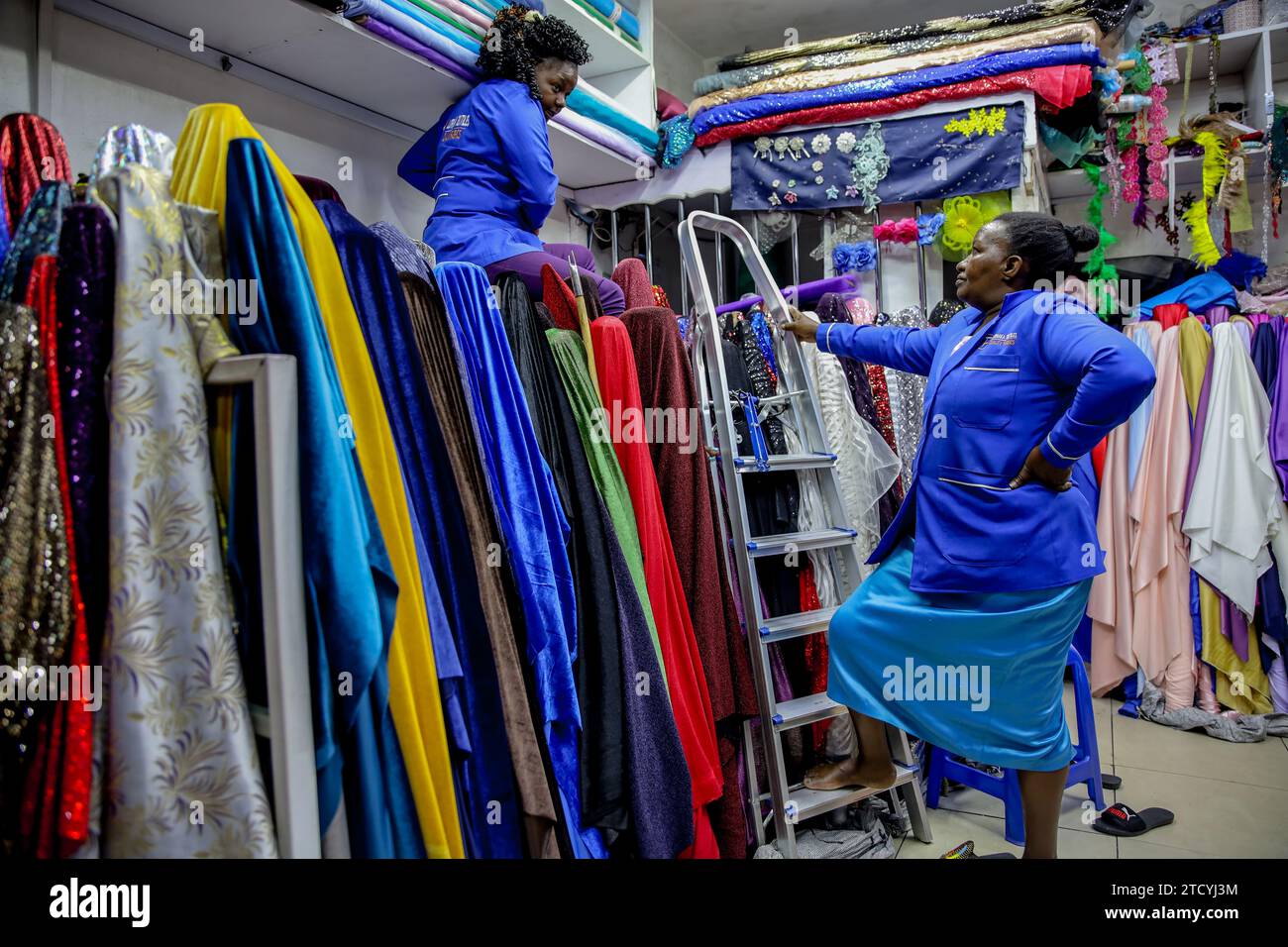 Traders selling their fabric products at their textile shop in Biashara ...