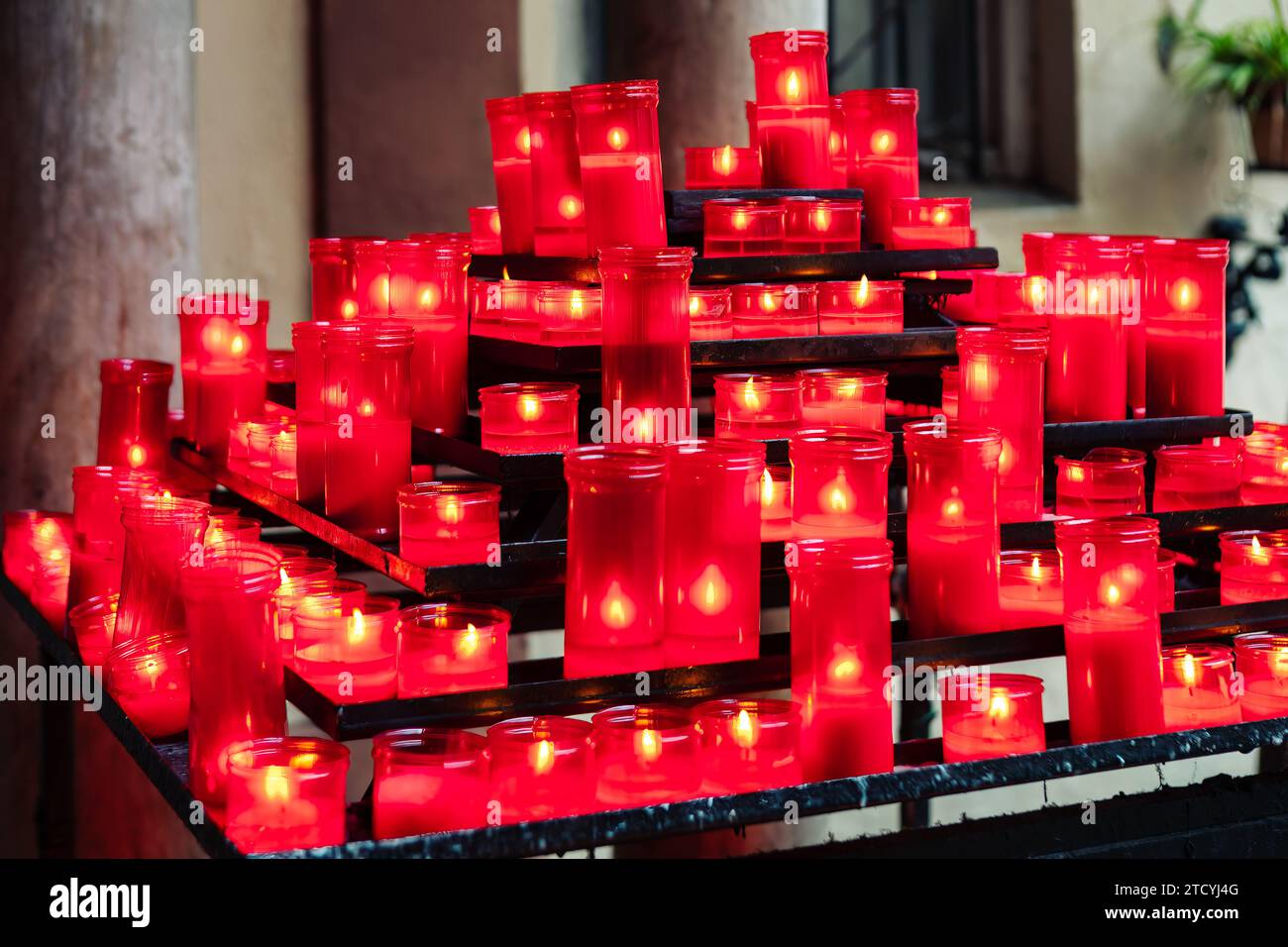 Red glass lamps with candles in a church Stock Photo - Alamy