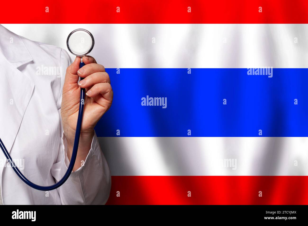 Thai doctor's hand with stethoscope on the background of flag of ...