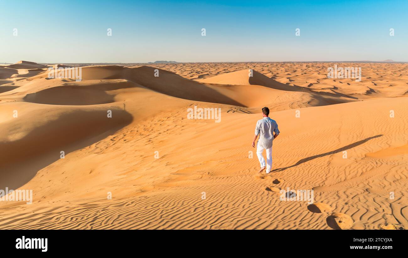 Dubai desert sand dunes, men on Dubai desert safari, United Arab ...
