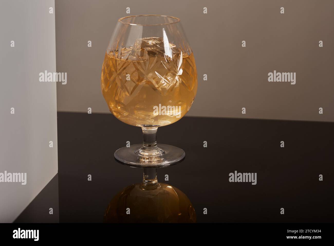 Glass of brandy,cognac with ice on a cool reflective surface Stock ...