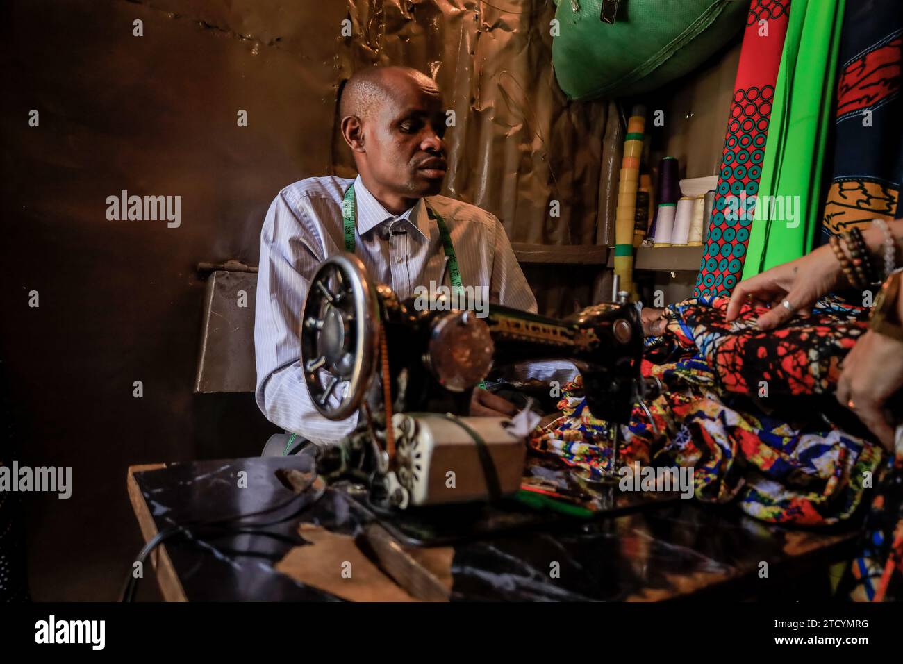 Richard Onyango (R) a tailor at Afrowema and Tatiana Teixeira checks on ...