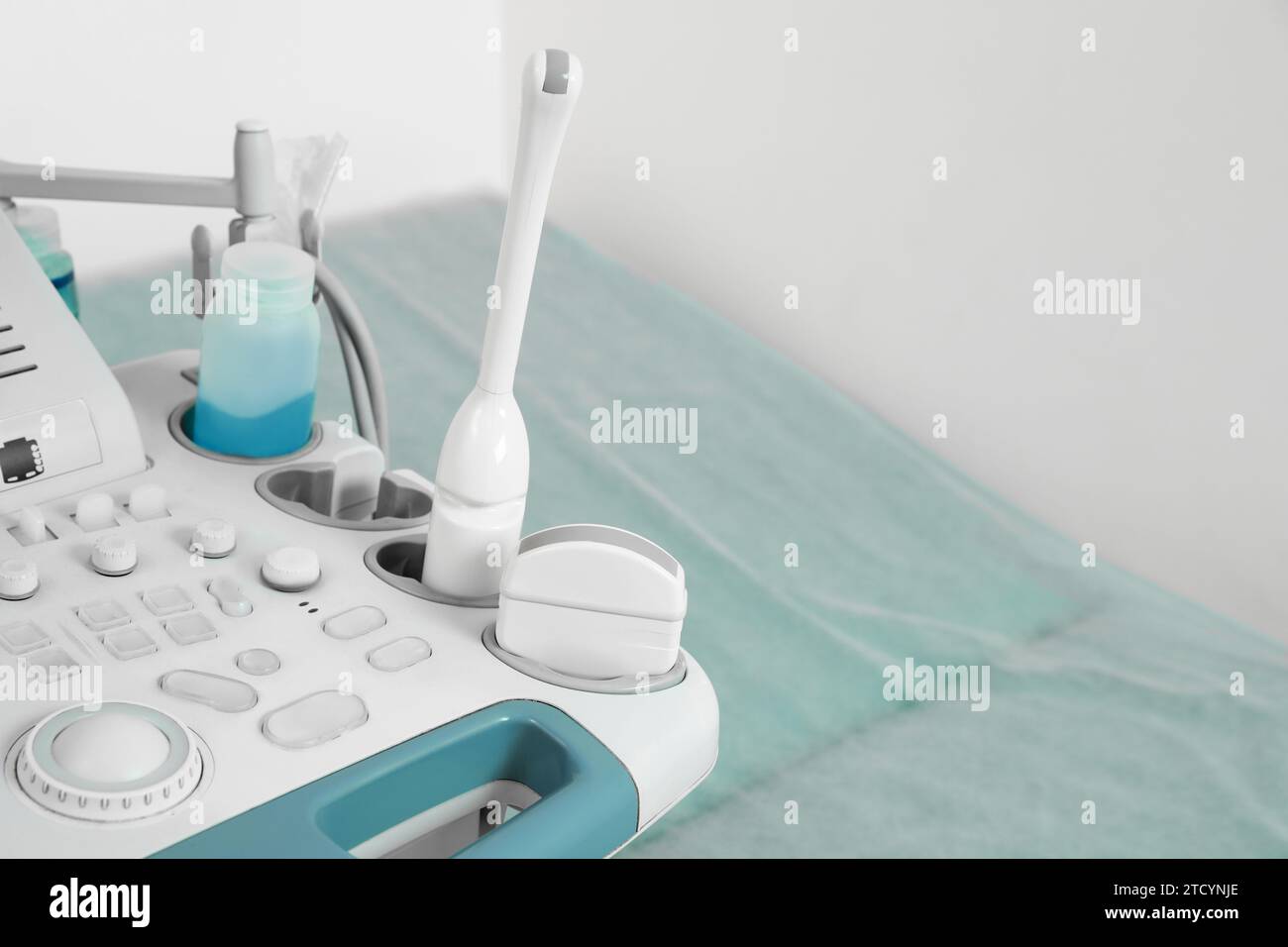 Ultrasound control panel and examination table in hospital, closeup ...