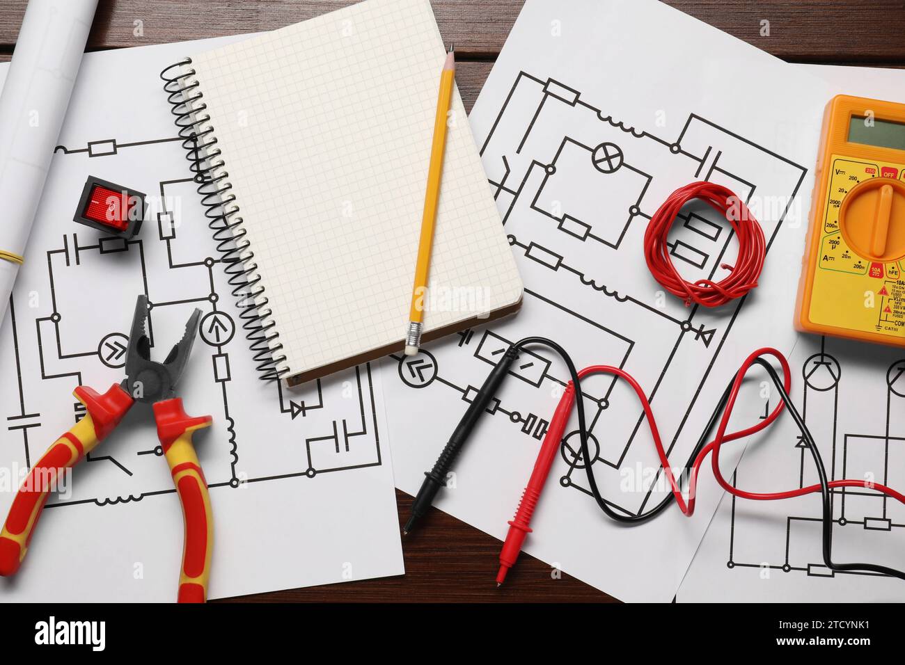 Flat lay composition with wiring diagrams and digital multimeter on ...
