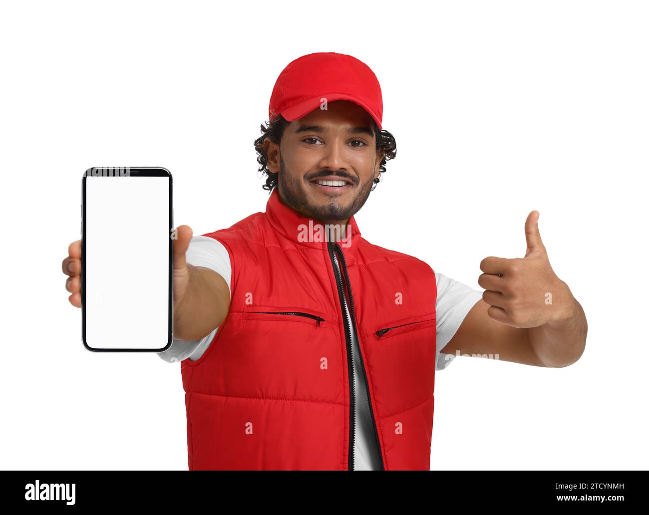 Happy courier holding smartphone with empty screen and showing thumbs ...
