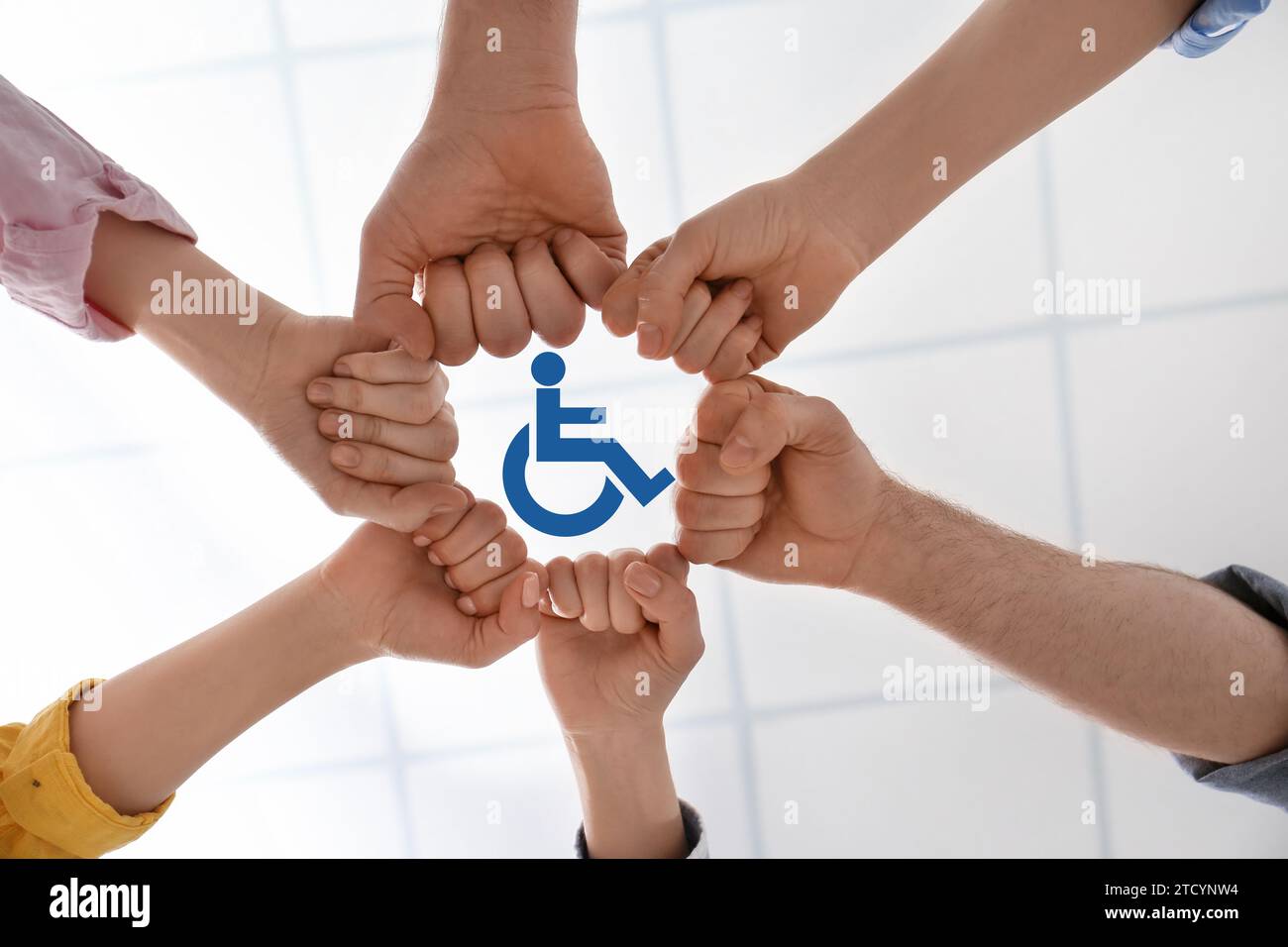 Inclusion concept. People holding fists together around international ...