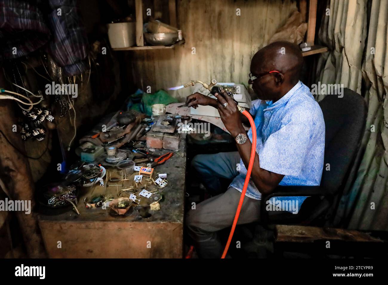 Samwel Mwangi makes jewelries at his shop in Kibera Slum on October 25, 2023 in Nairobi, Kenya ...