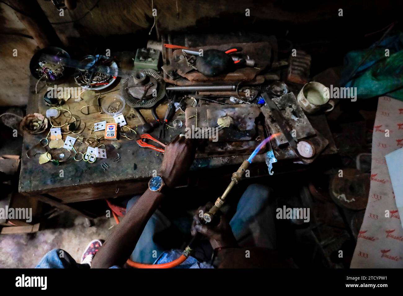 Samwel Mwangi makes jewelries at his shop in Kibera Slum on October 25 ...