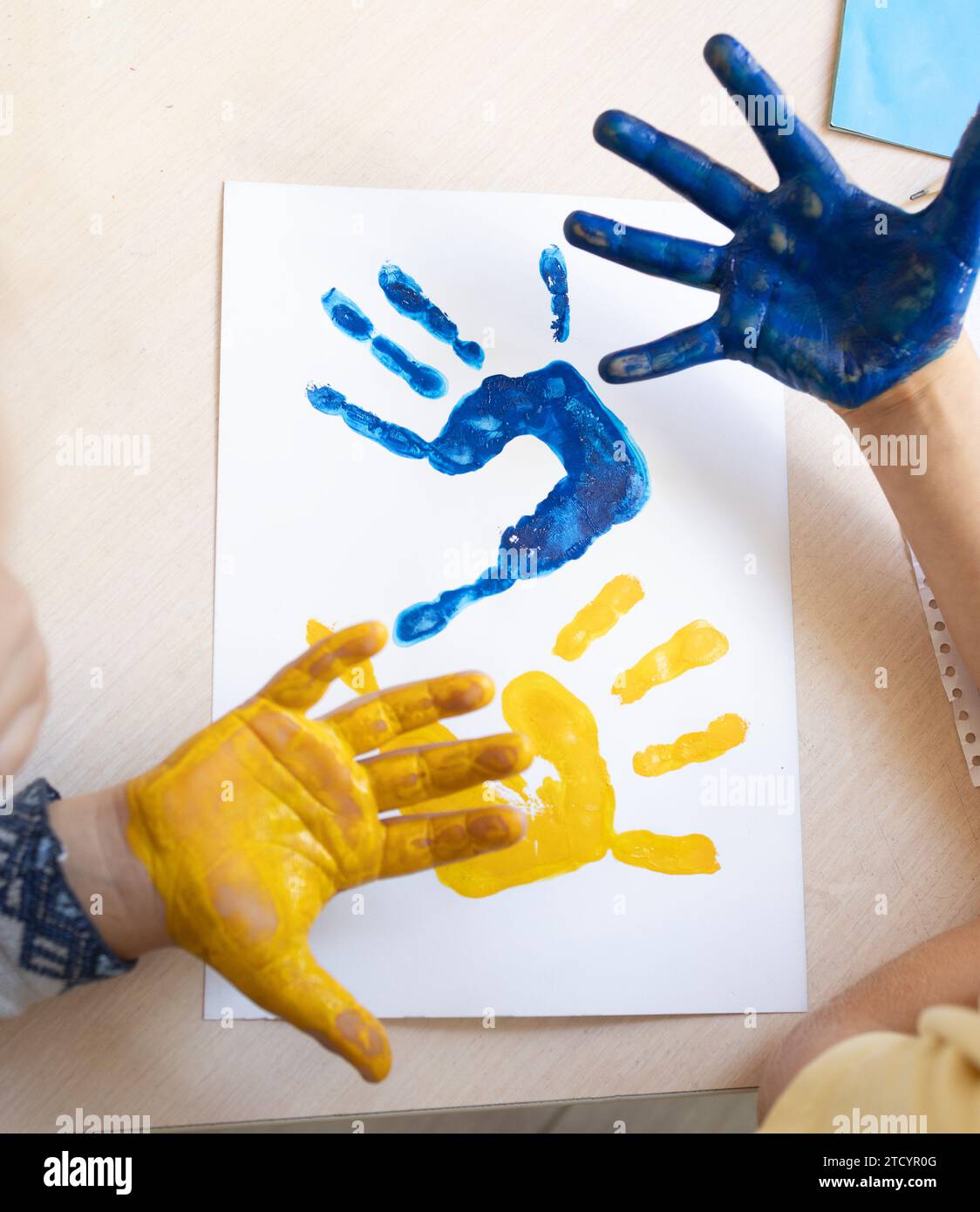 Colorful prints of children's handprints, painted in the yellow and ...