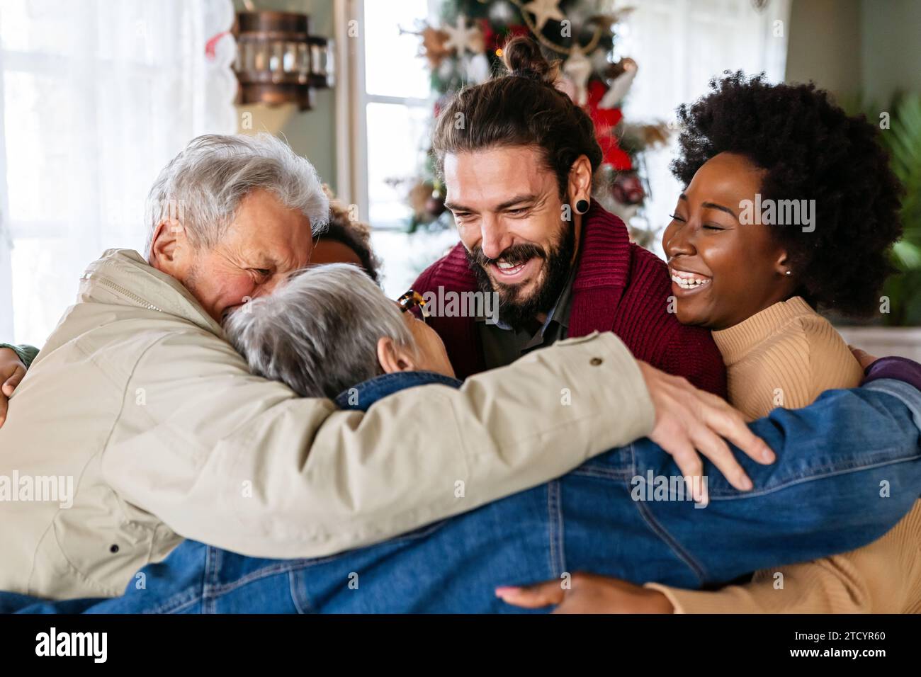 Happy multiethnic multi-generational family enjoying Christmas time ...