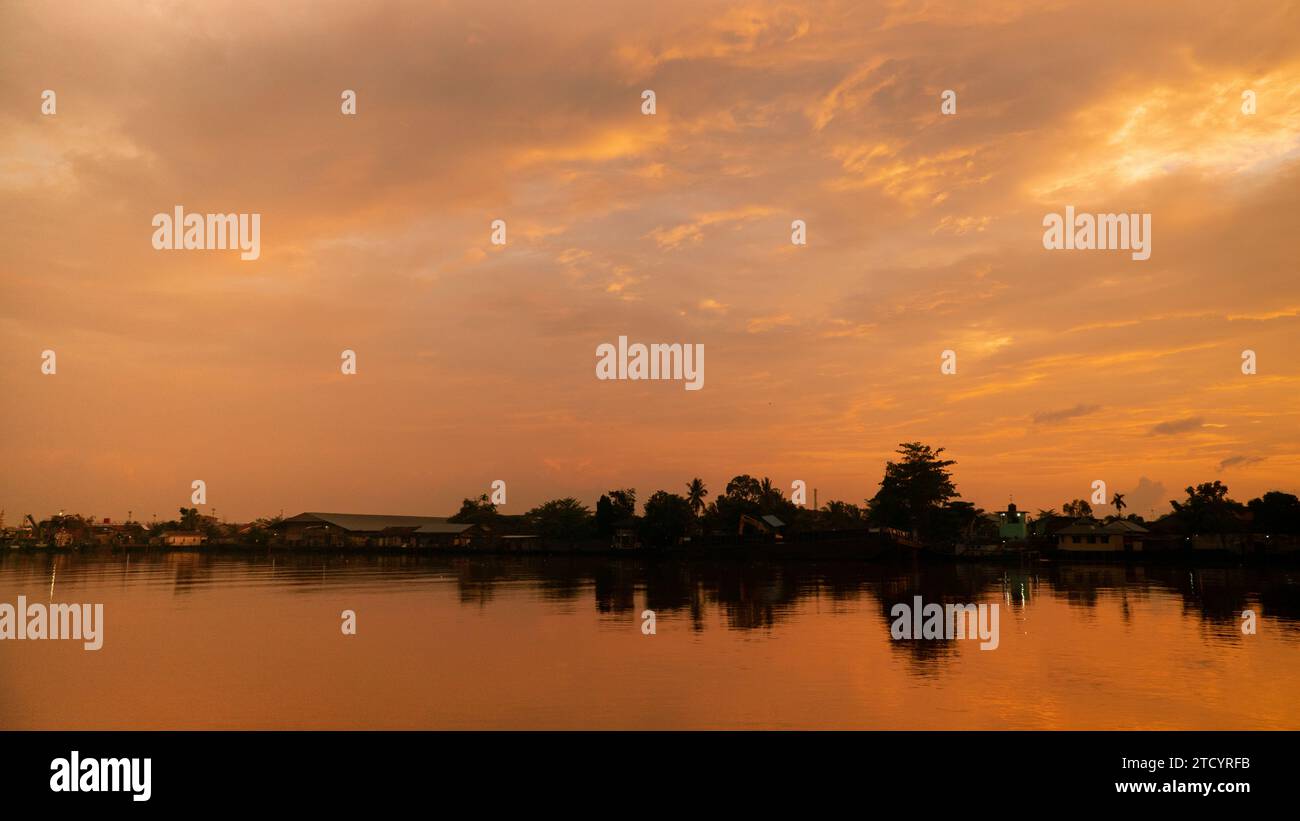 Sunset with a very beautiful super orange sky Stock Photo - Alamy